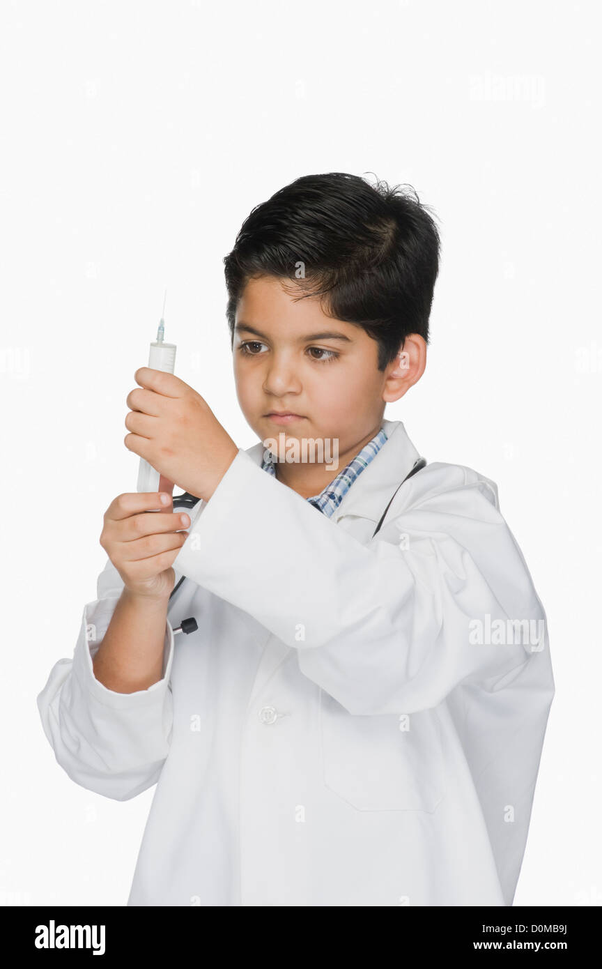 Boy imitating a doctor and holding a medical injection Stock Photo - Alamy