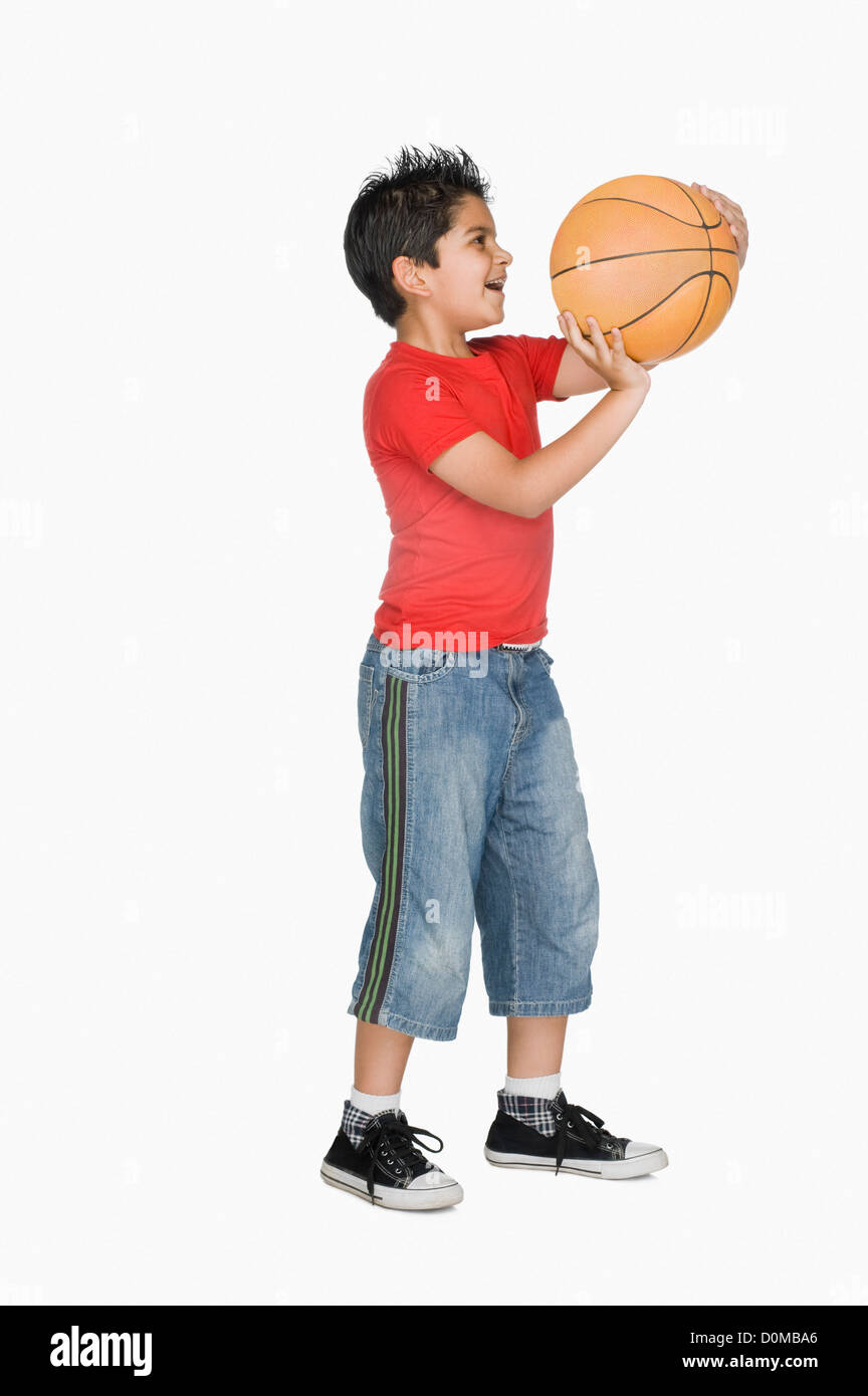 Boy throwing a basketball Stock Photo - Alamy