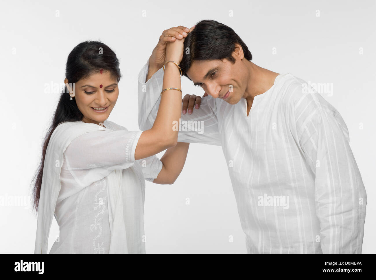 Man putting a woman's hand on his head Stock Photo - Alamy