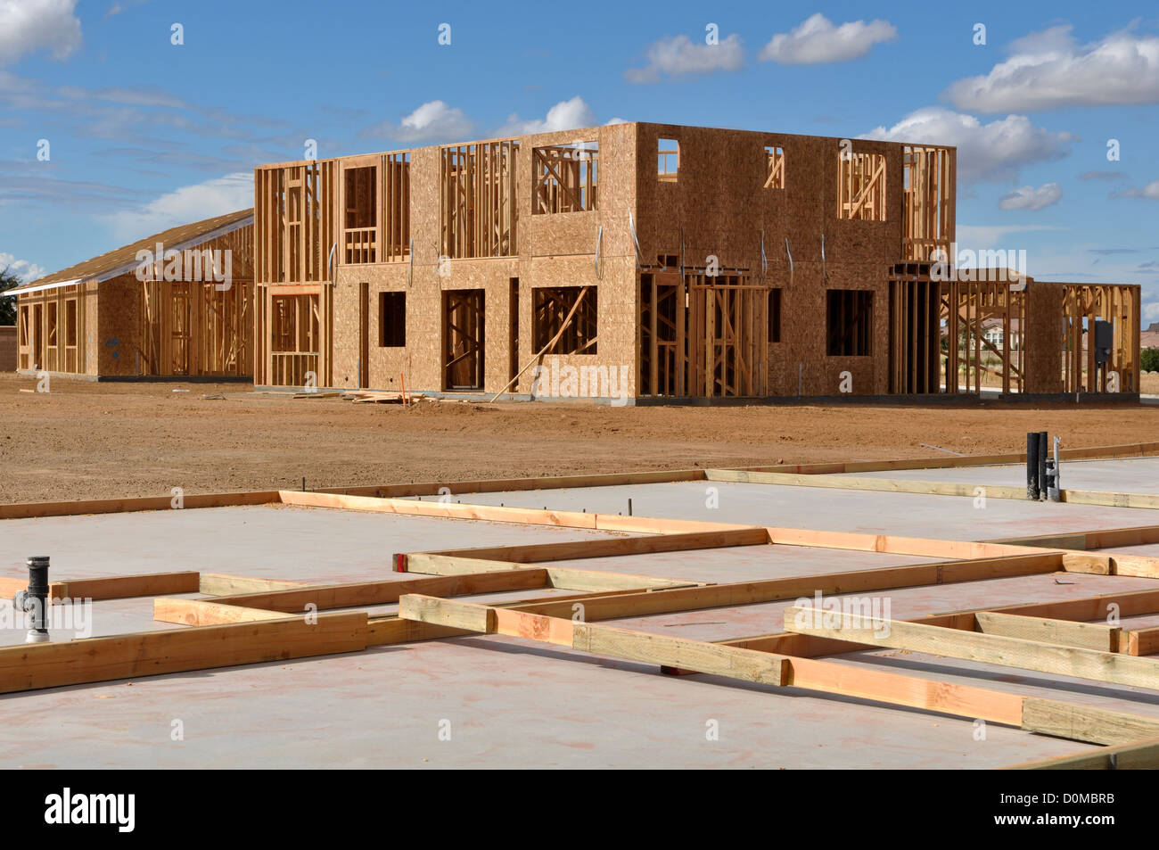 New Home Foundation Foreground with Construction in Background Stock ...
