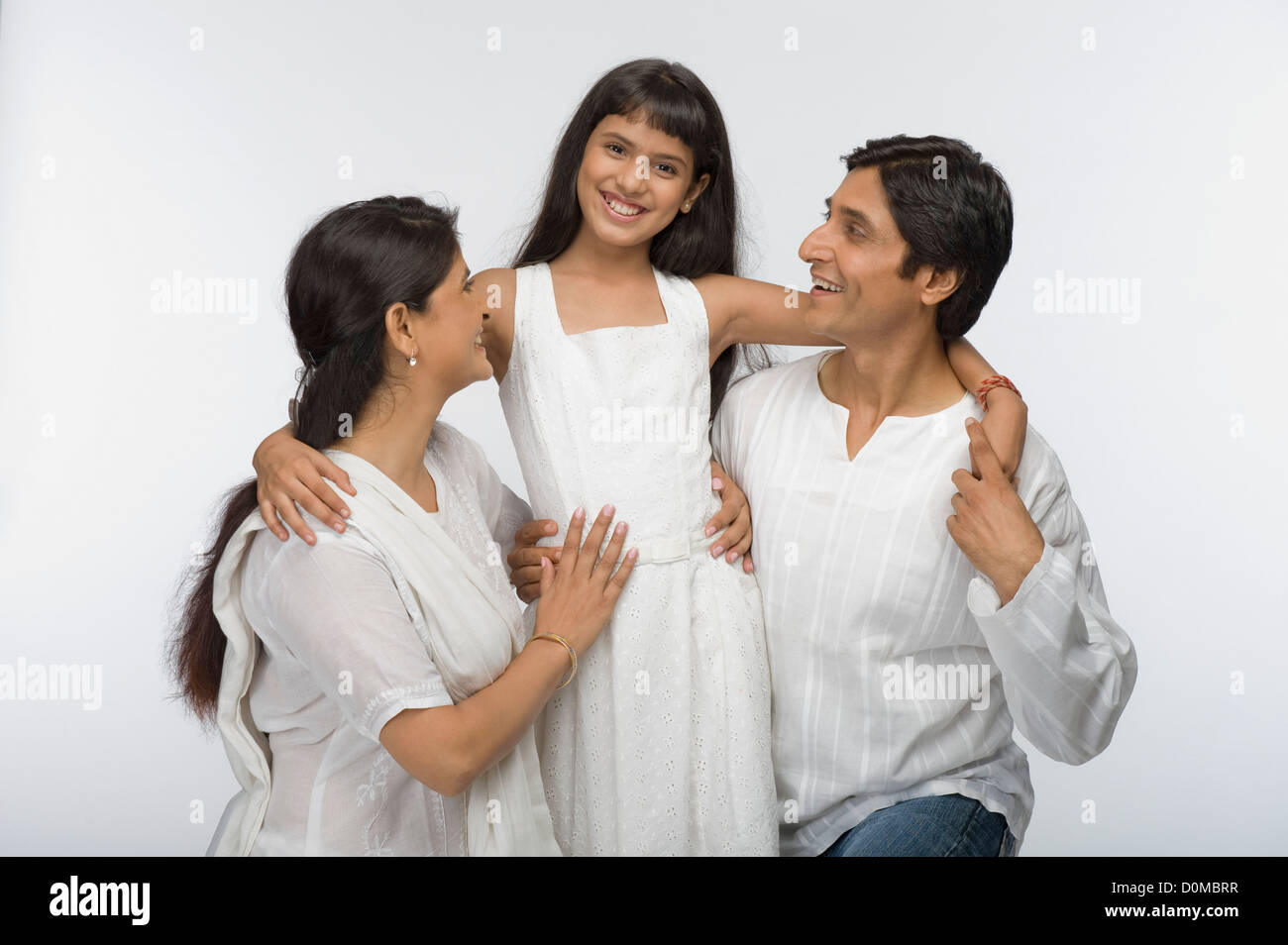 Parents smiling with their daughter Stock Photo - Alamy