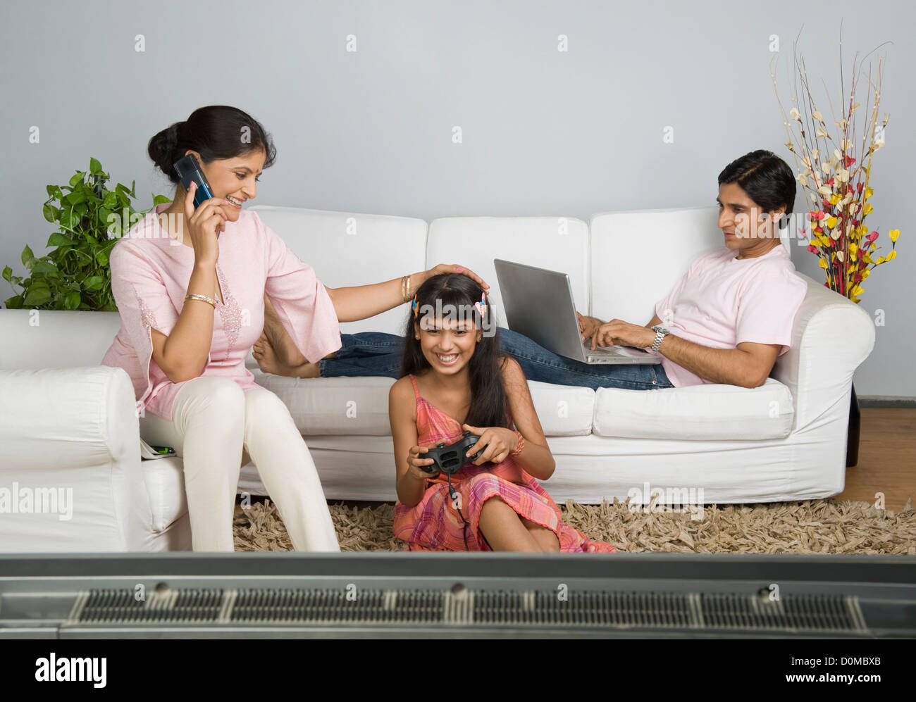 Family involved in different leisure activities Stock Photo - Alamy