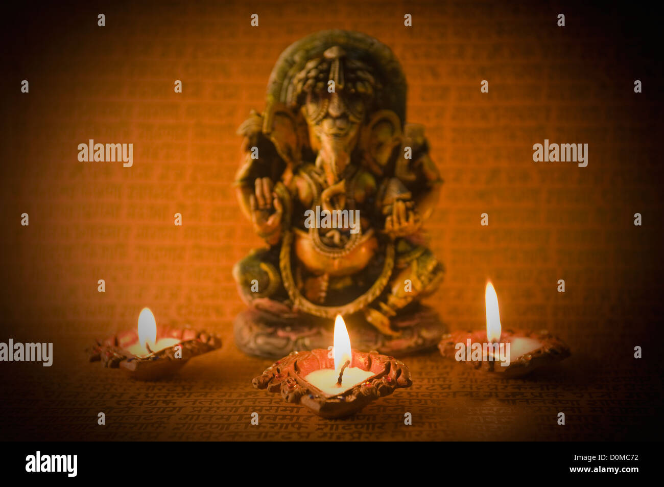 Diwali oil lamps in front of an idol of Lord Ganesha Stock Photo - Alamy
