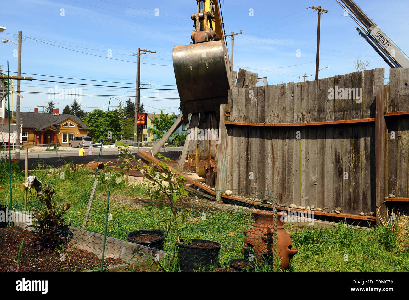 Fence being demolished by an excavator Stock Photo - Alamy