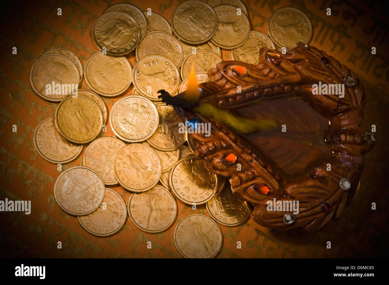 Indian coins with a Diwali oil lamp Stock Photo - Alamy