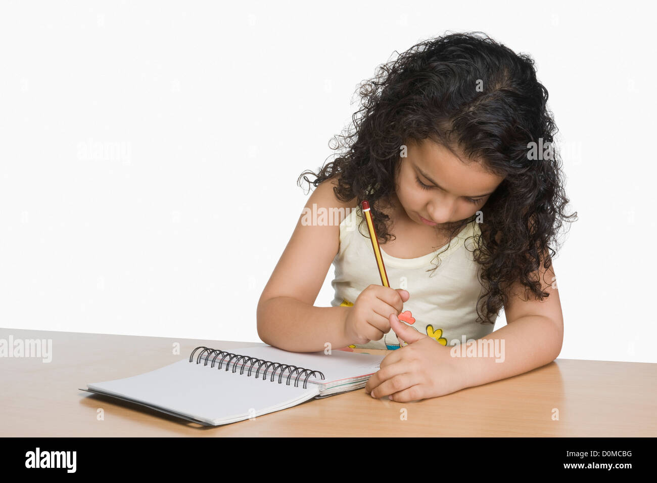 Indian girl writing in notebook hi-res stock photography and images - Alamy