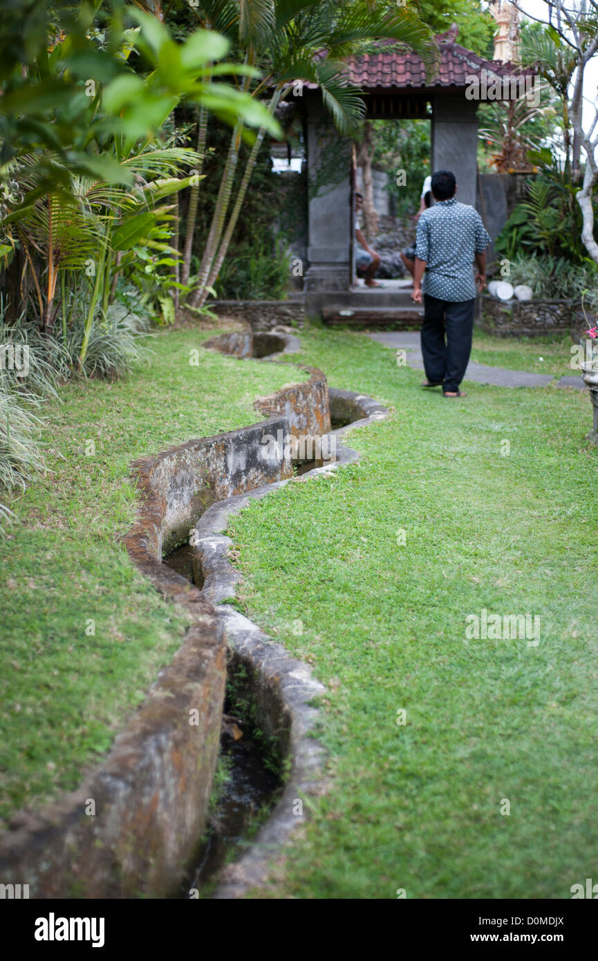 A man walking by a water path Stock Photo - Alamy