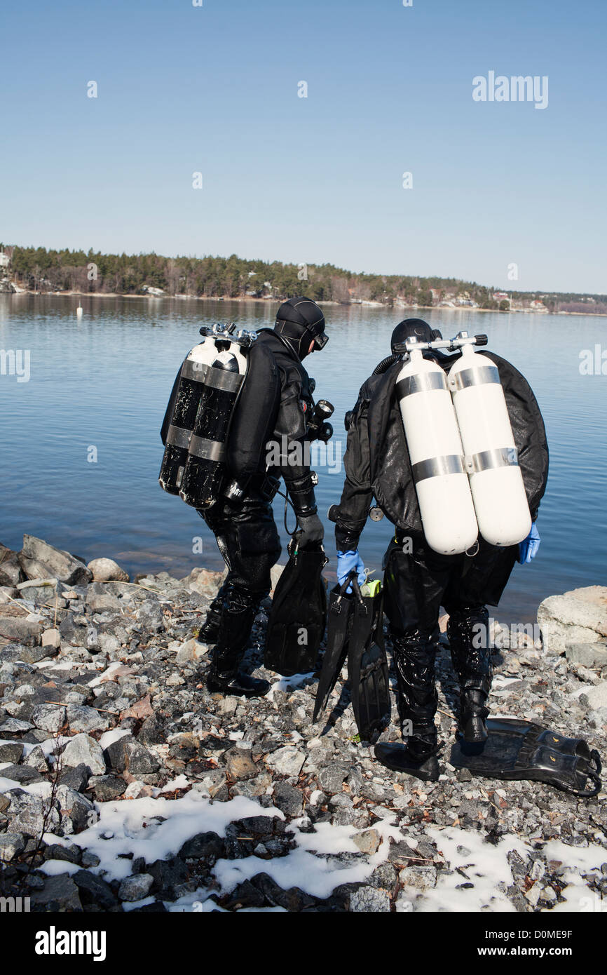 Two men preparing for diving Stock Photo - Alamy