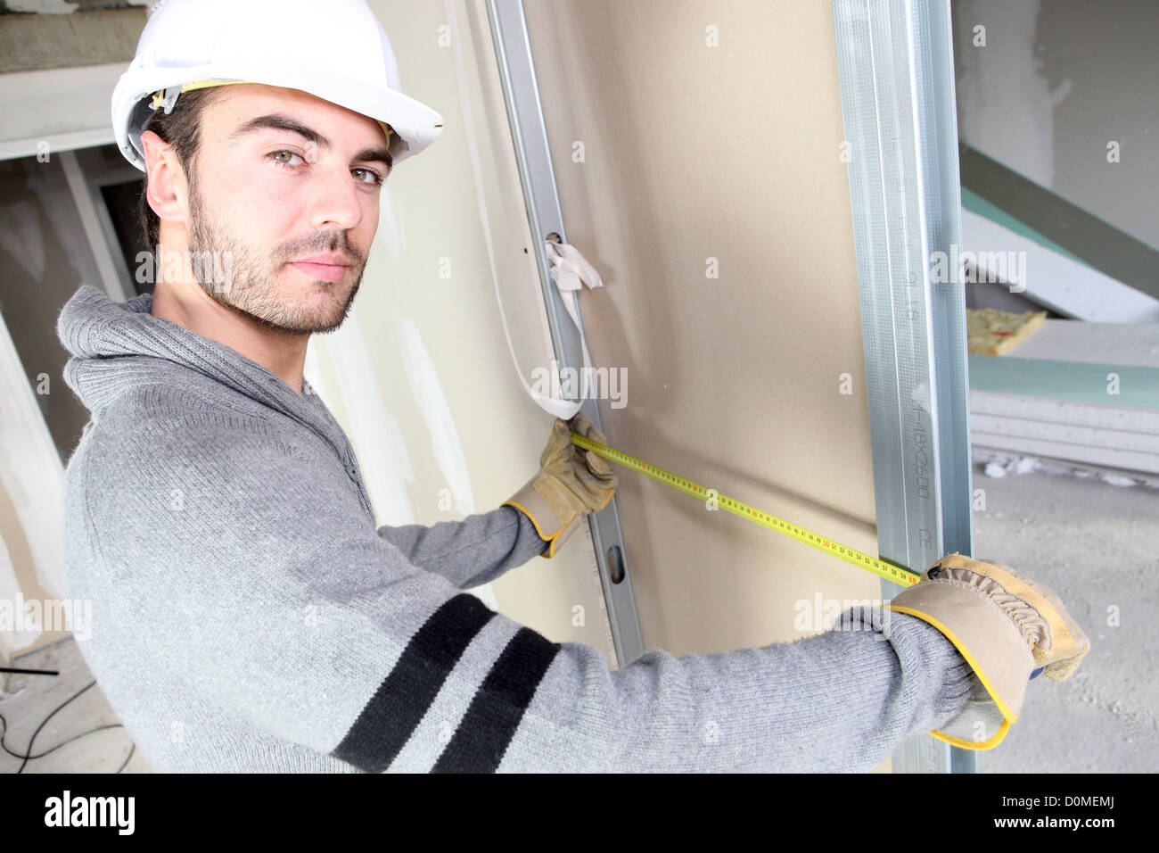 Man measuring width of wall Stock Photo - Alamy