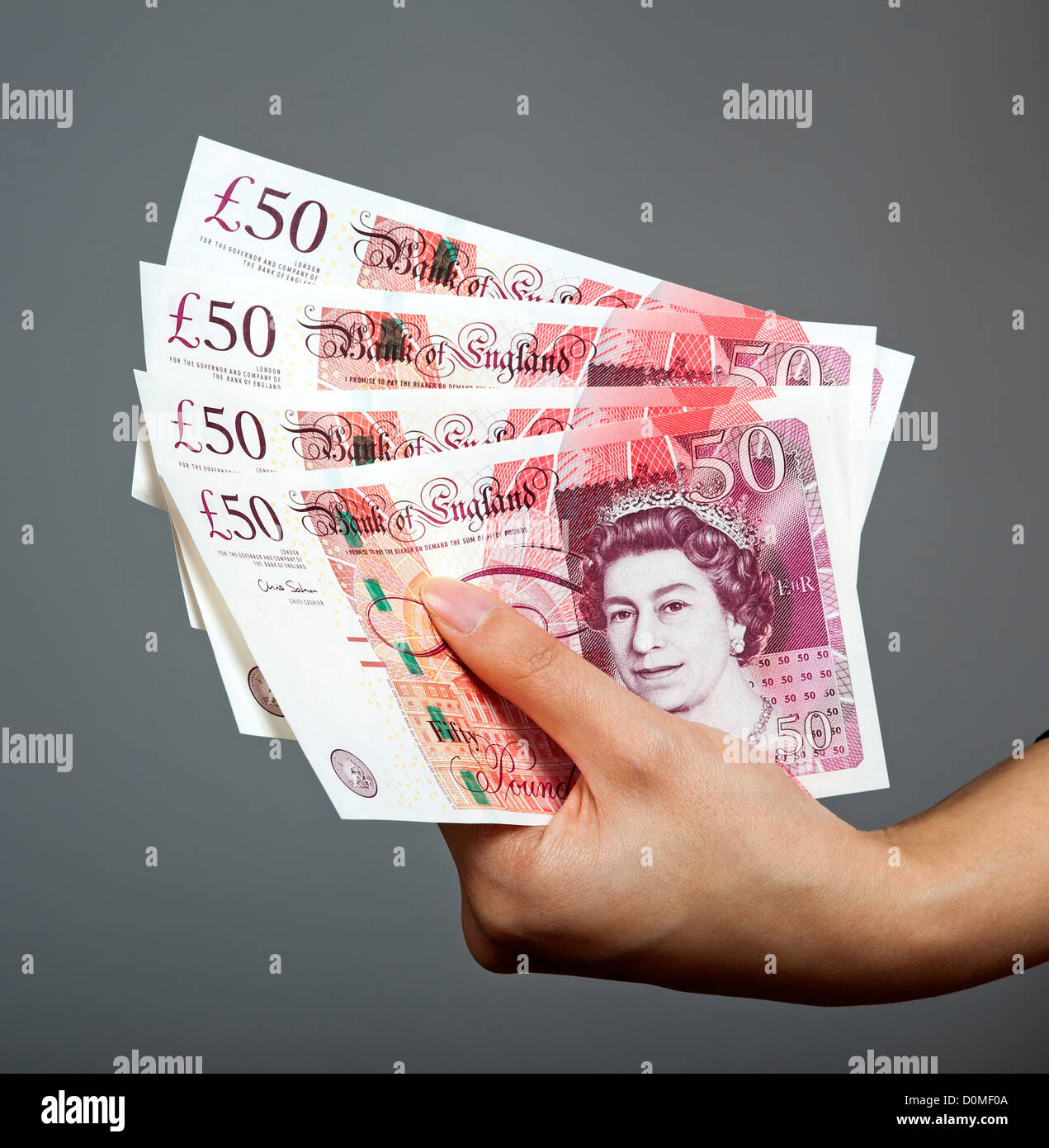 Hand holding british money hi-res stock photography and images - Alamy