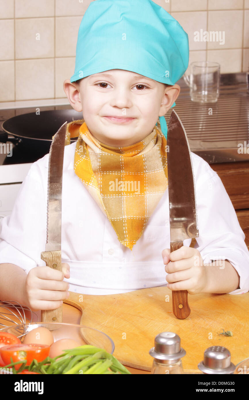 Smiling cook with two knives Stock Photo - Alamy