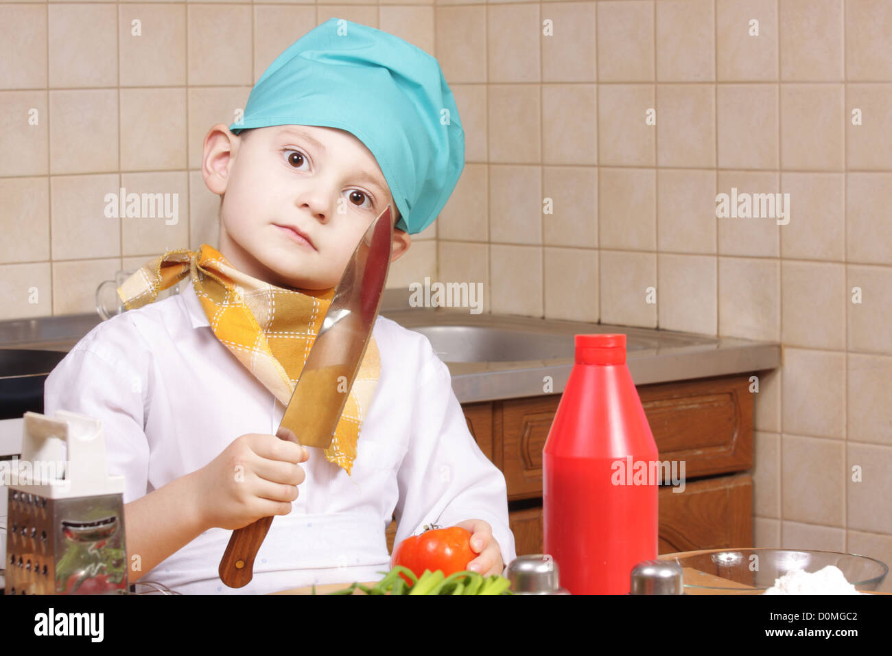 Cook with knife and tomato Stock Photo - Alamy