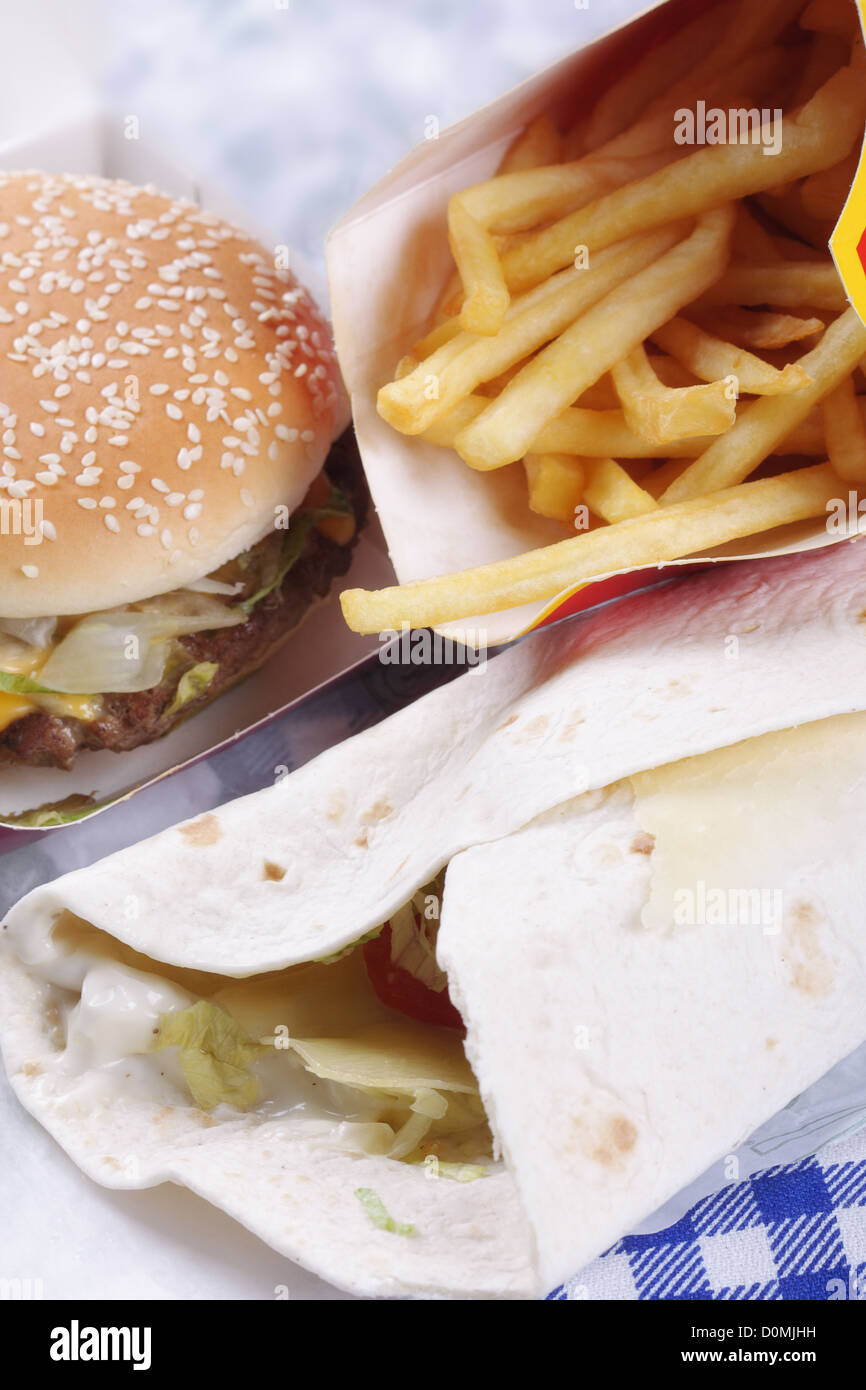 Junk food on table Stock Photo - Alamy