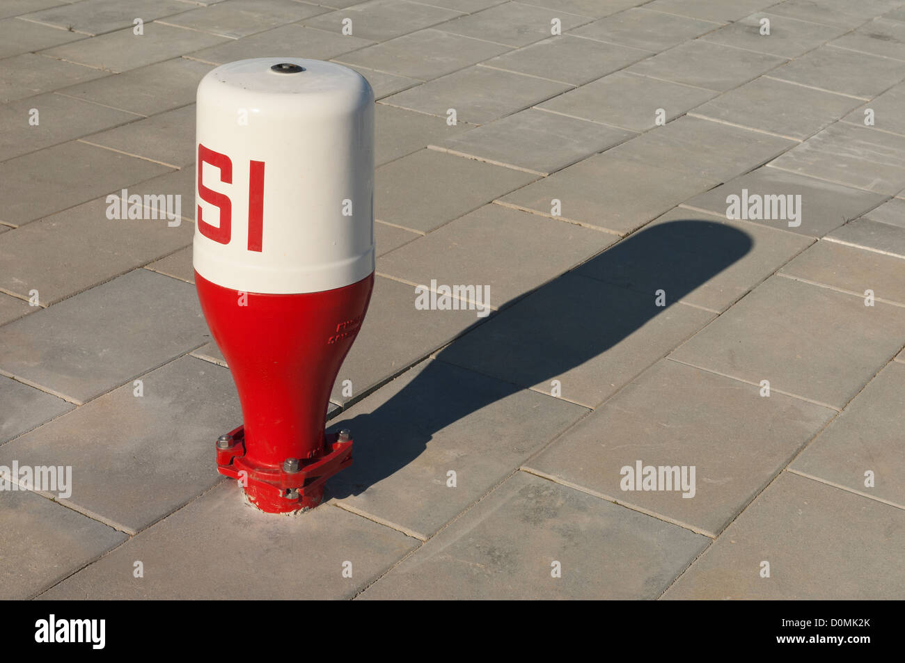 Modern fire hydrant with a protecting hood of the valve in a slab ...