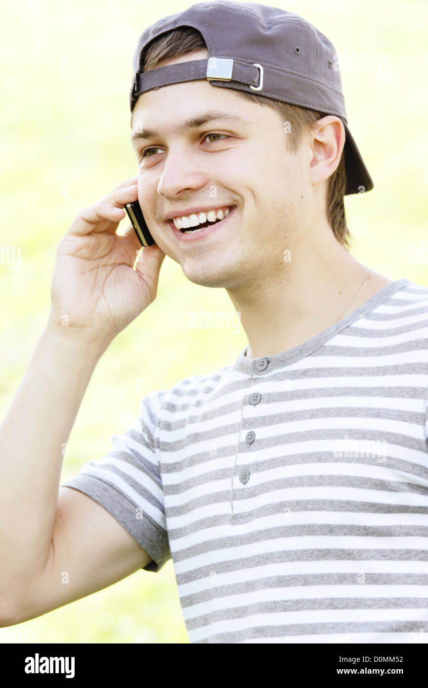 Smiling guy with phone Stock Photo - Alamy