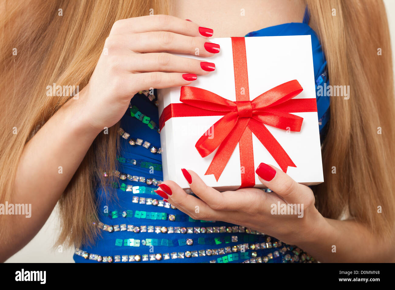 Time gifts. Gift box in the hands of a young girl. Closeup Stock Photo ...