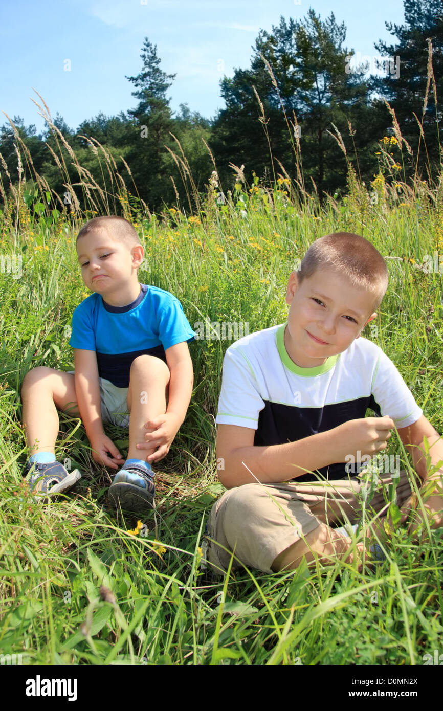 Kids in grass Stock Photo - Alamy