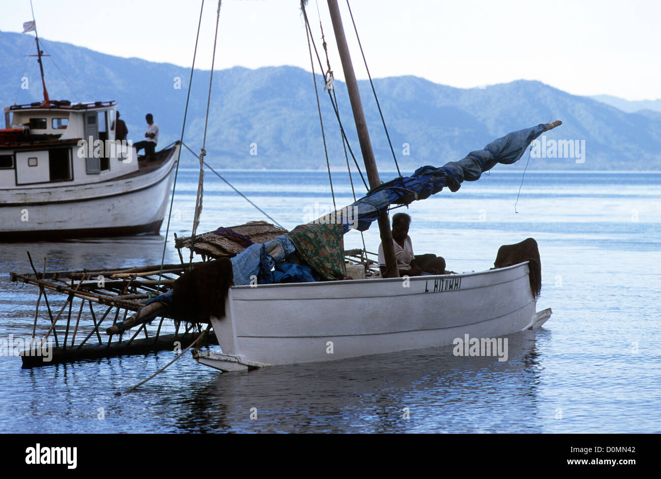 Papua New Guinea, Alotau, fisherman and boat in the Sanderson Harbour ...
