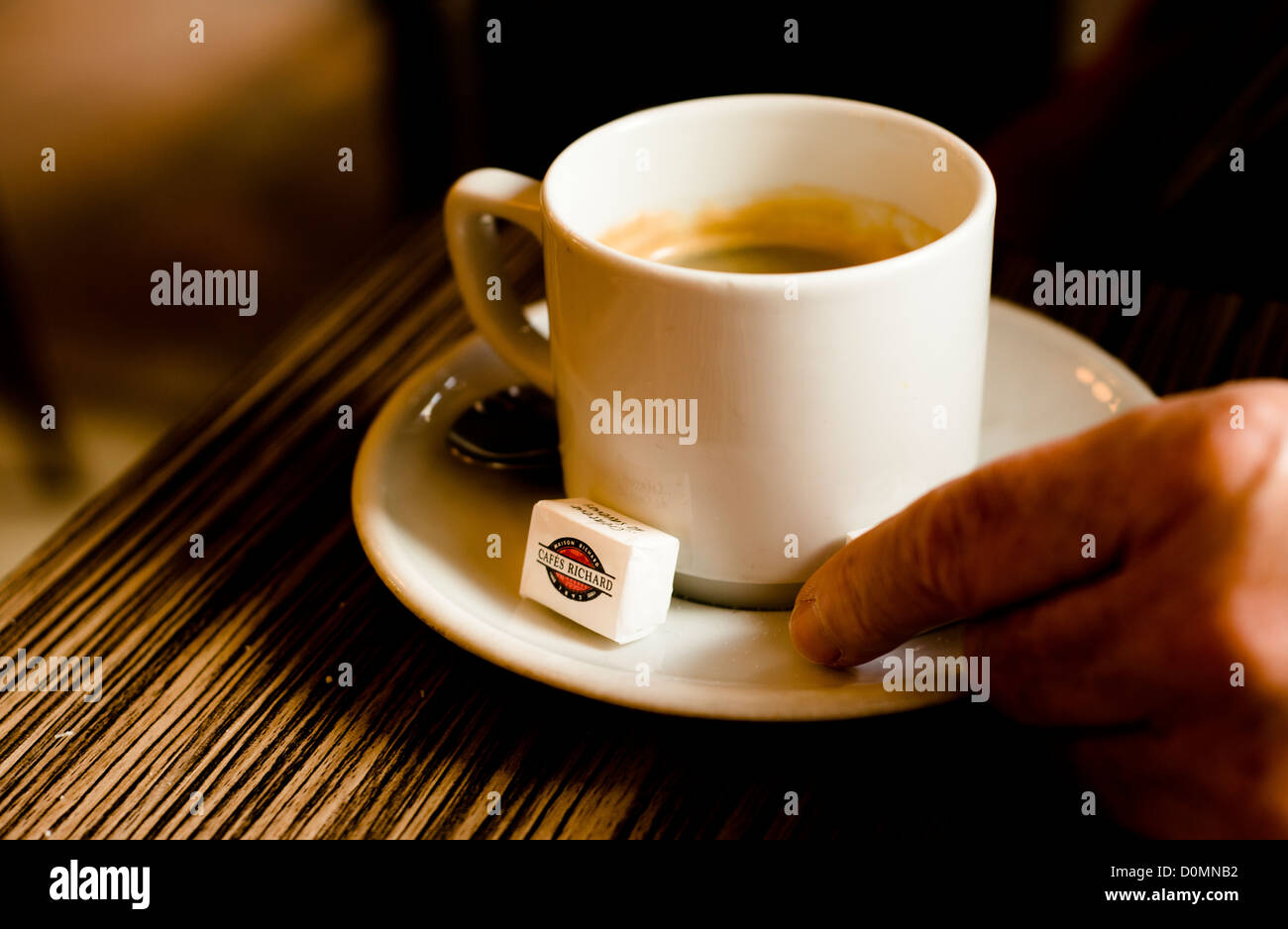 A cup of coffee with a sugar lump on the saucer Stock Photo - Alamy