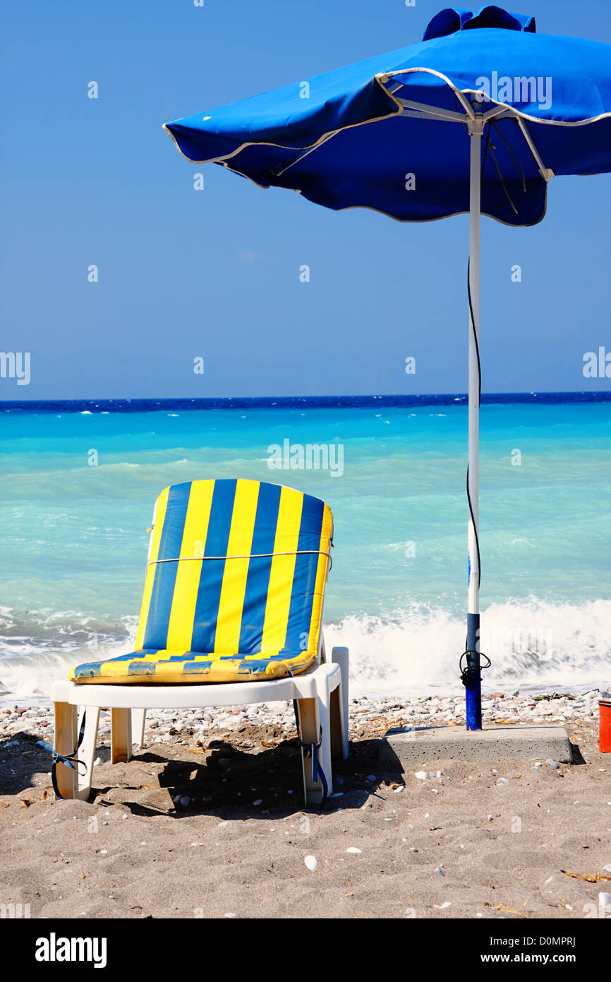 Striped chair under sunshade Stock Photo - Alamy