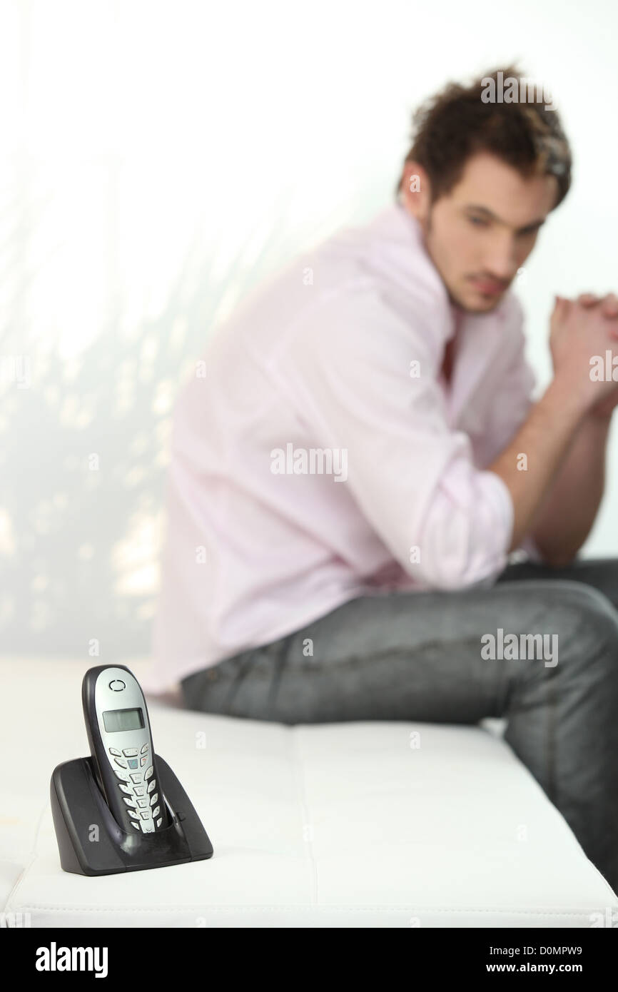 Man waiting for phone call Stock Photo - Alamy