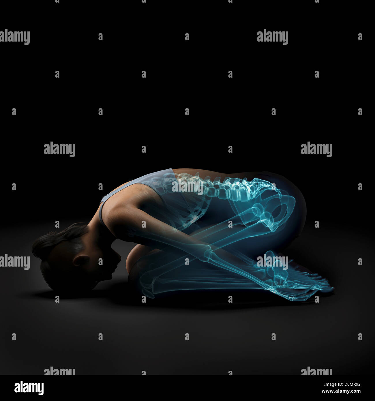 Skeleton layered over a female body in child's pose showing the ...