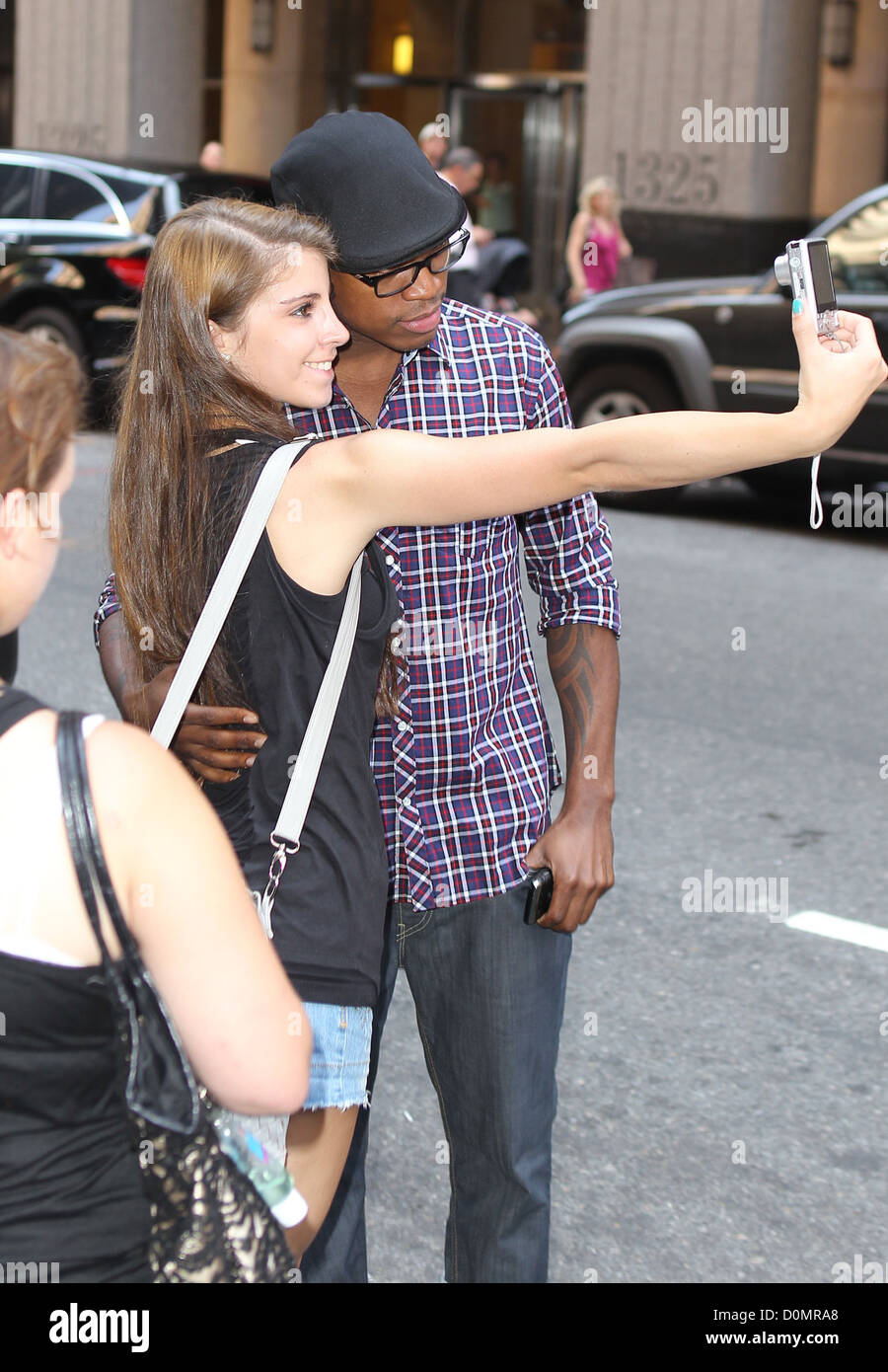 Ne-Yo poses with fans outside his hotel in New York New York City, USA ...