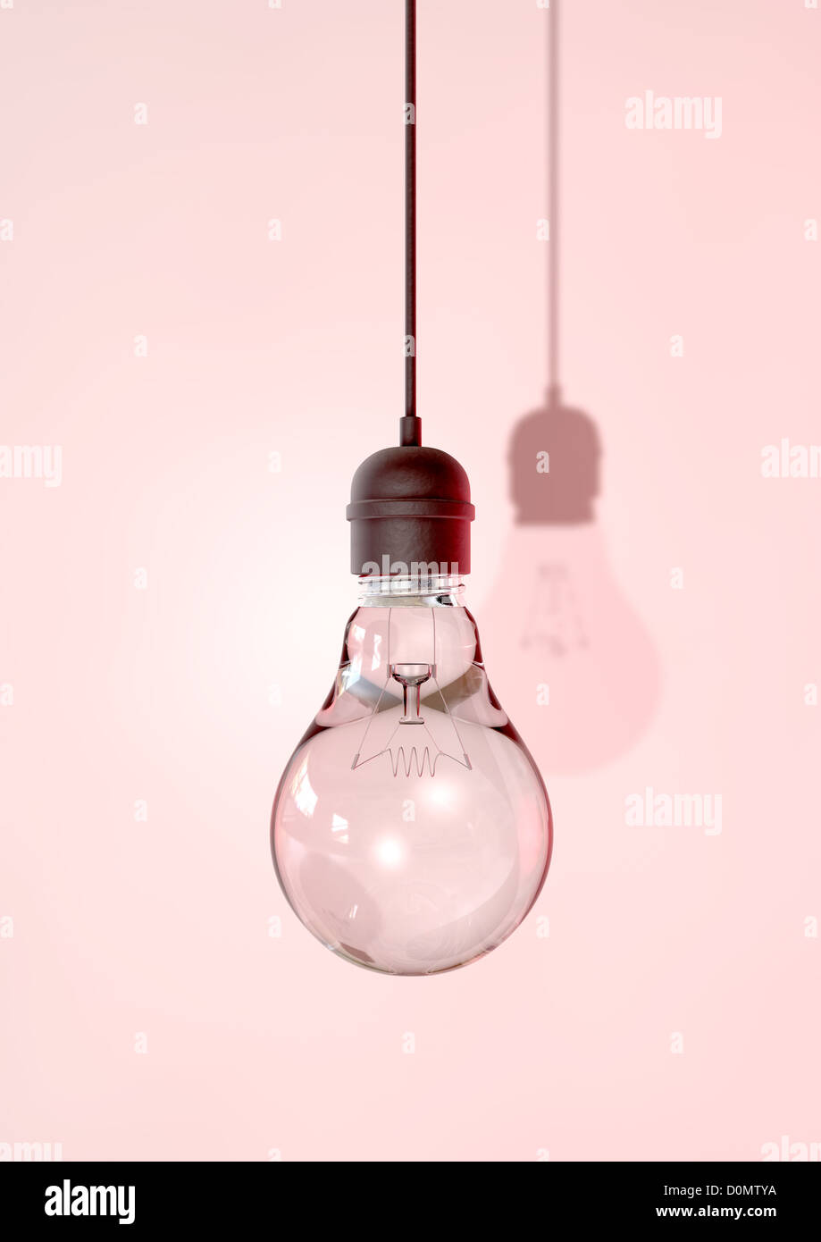 A regular unlit light bulb fitted into a light fitting hanging from a ...