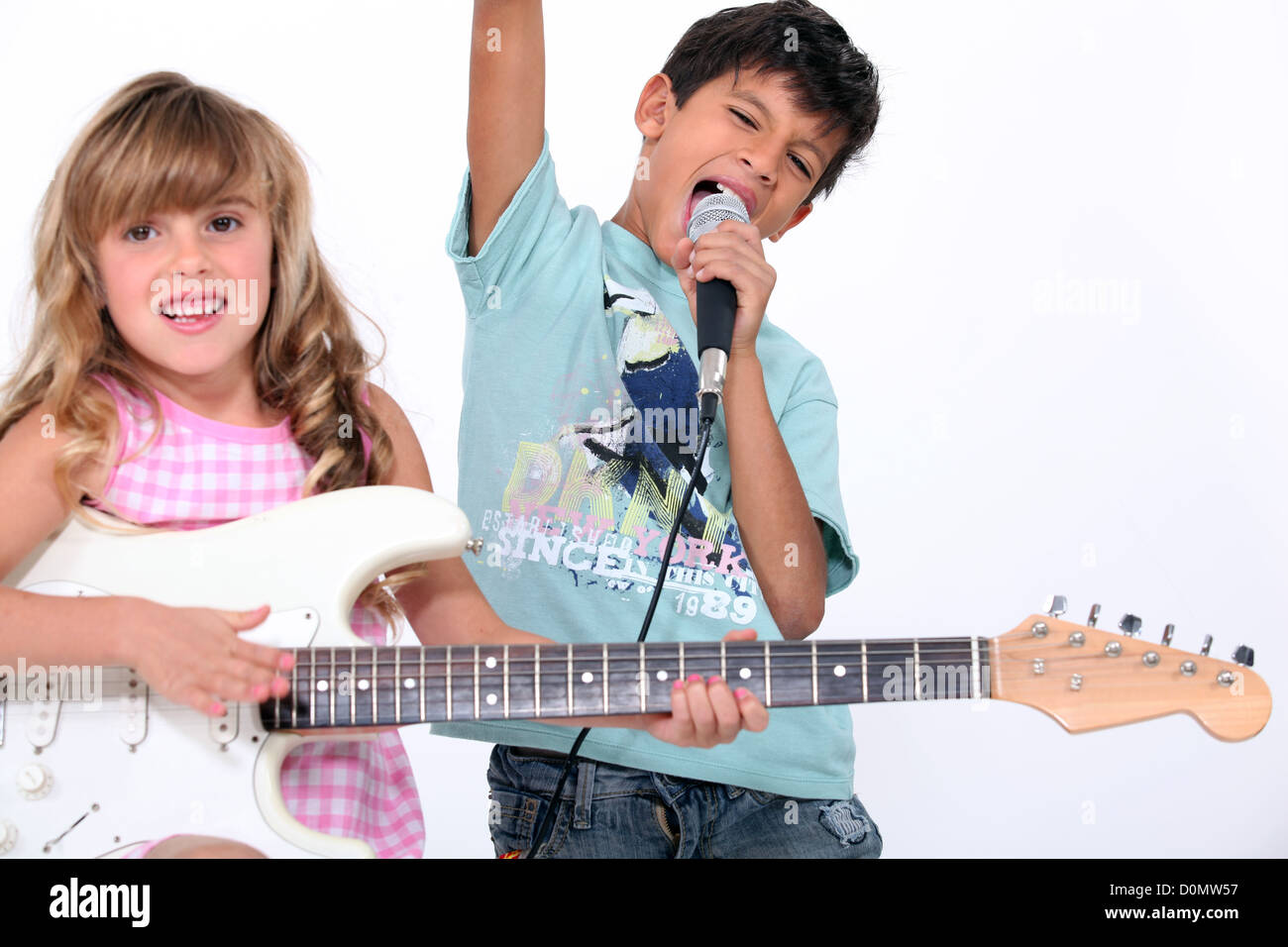 two kids doing a rock band Stock Photo - Alamy