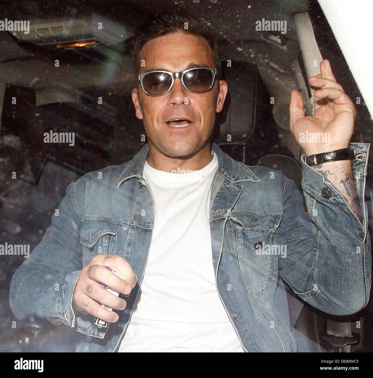 Robbie williams wearing denim jacket hi-res stock photography and ...