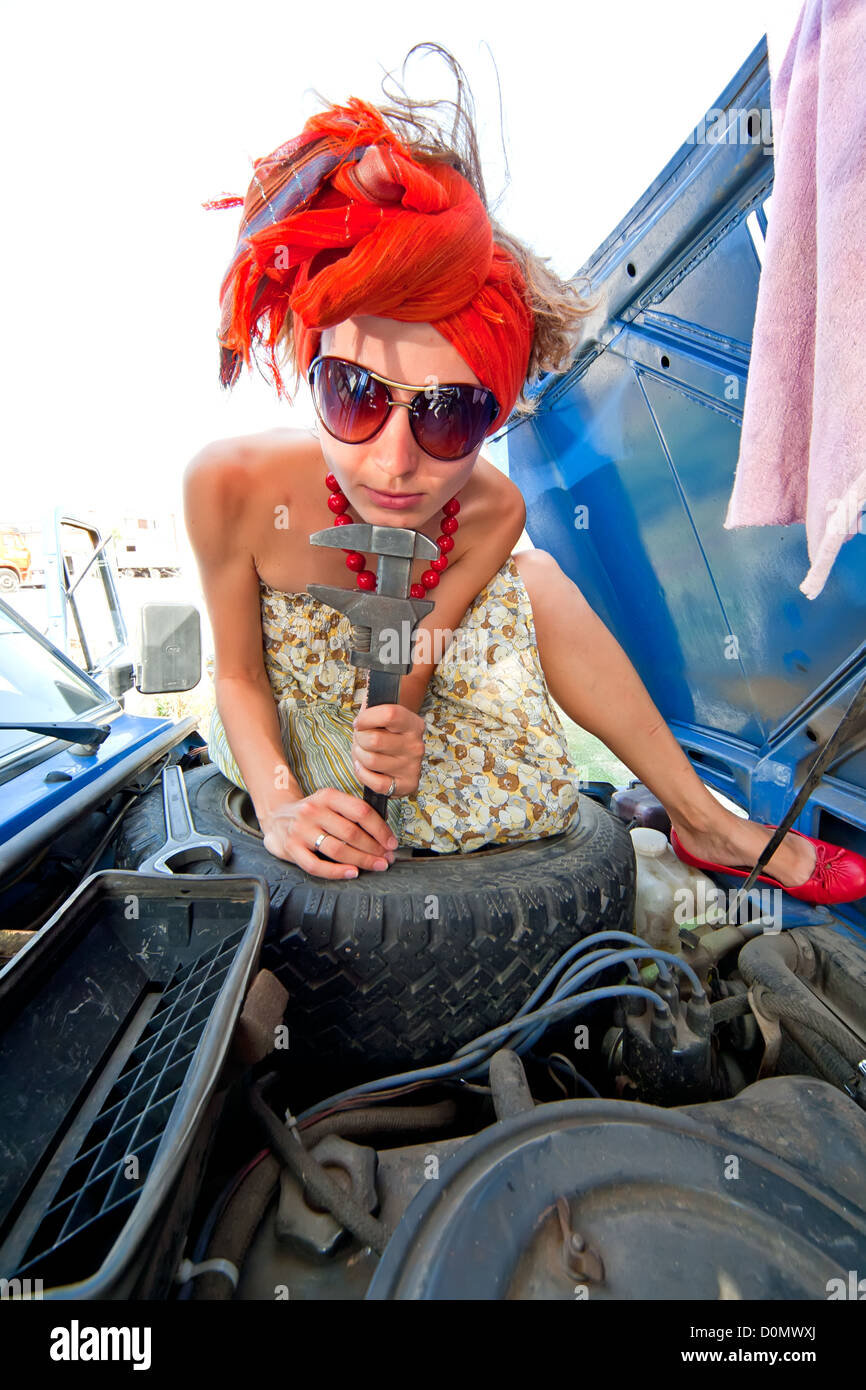 Vintage girl repairing car engine Stock Photo - Alamy