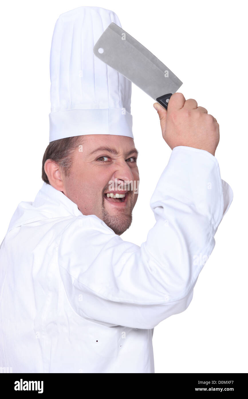 Chef in whites wielding a chopper Stock Photo - Alamy
