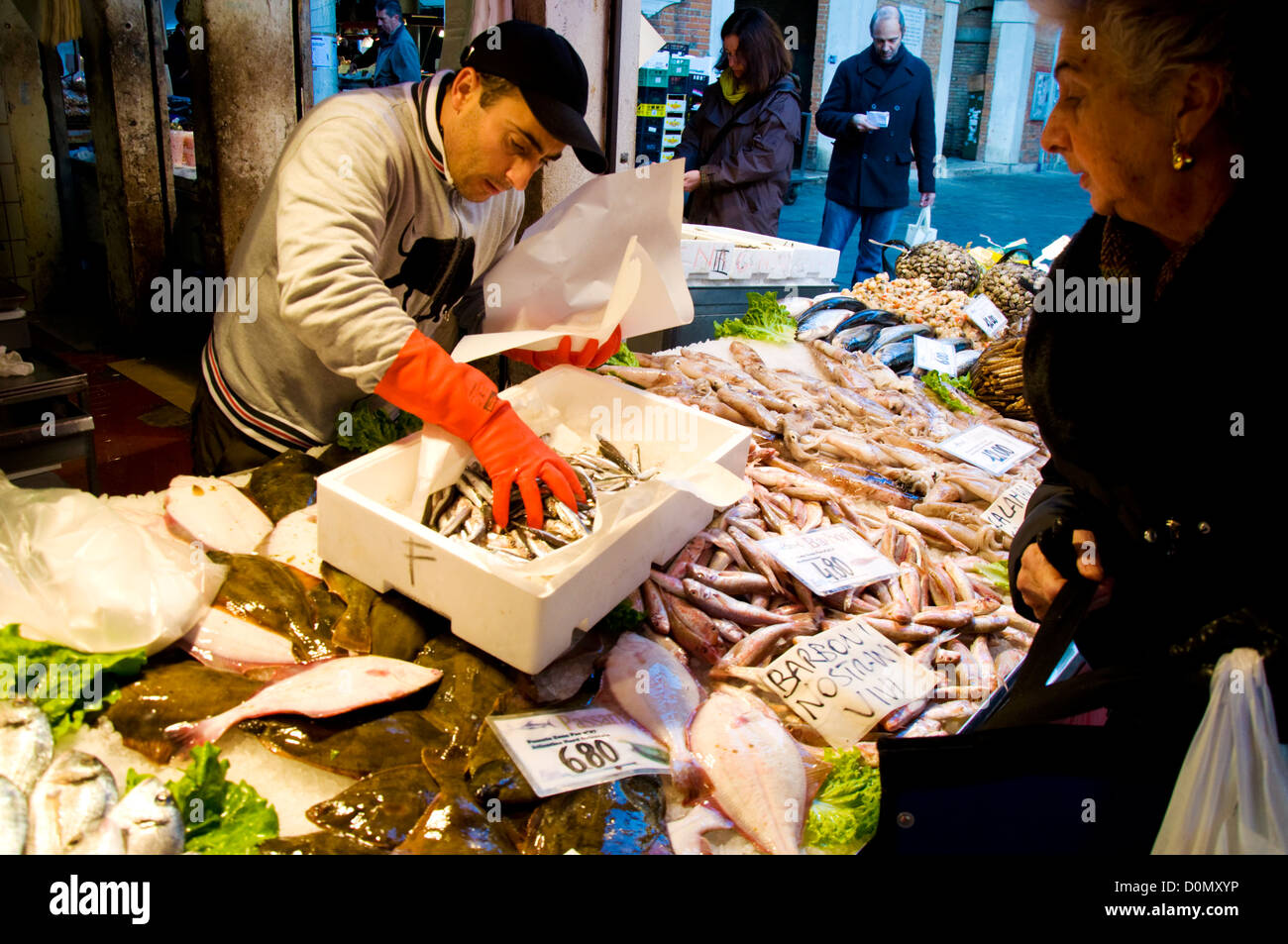 Fishmonger in Fish Market a senior woman buying Stock Photo - Alamy