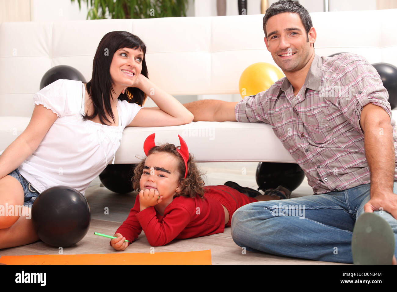 Parents with children dressed as devil Stock Photo - Alamy
