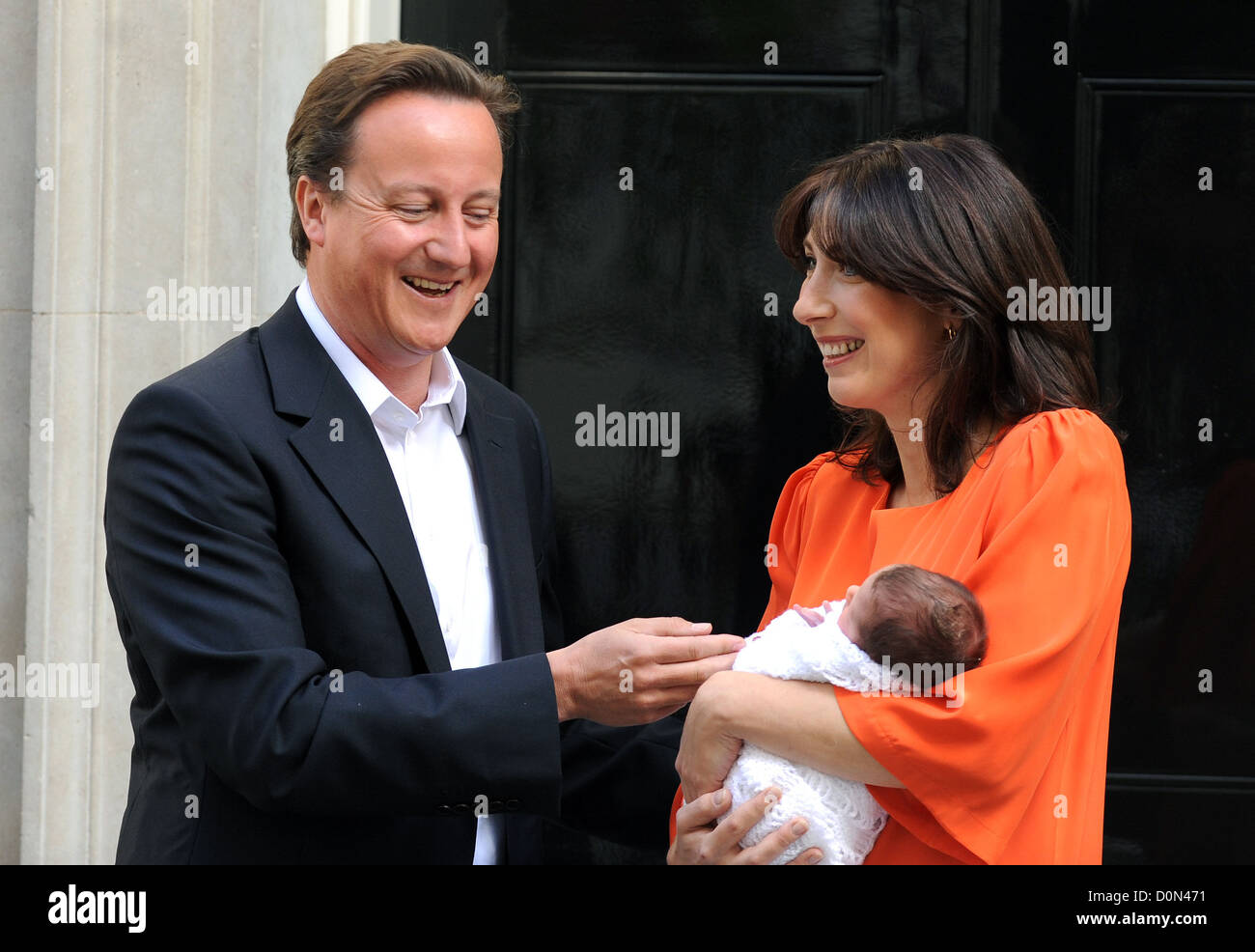 Prime Minister David Cameron returns to 10 Downing Street with his wife ...