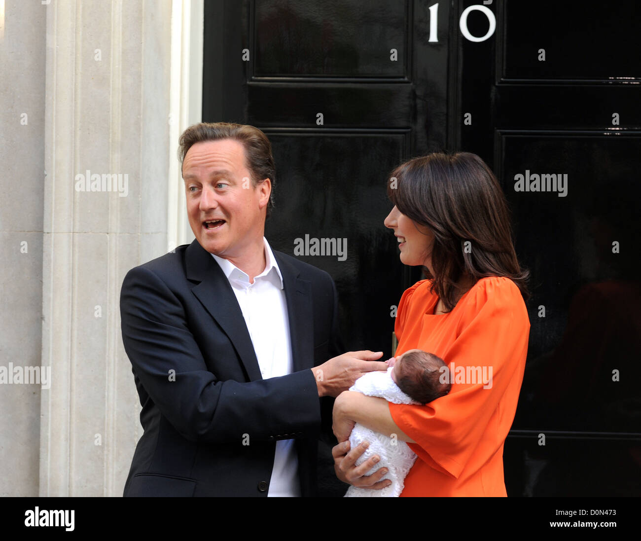 Prime Minister David Cameron returns to 10 Downing Street with his wife ...