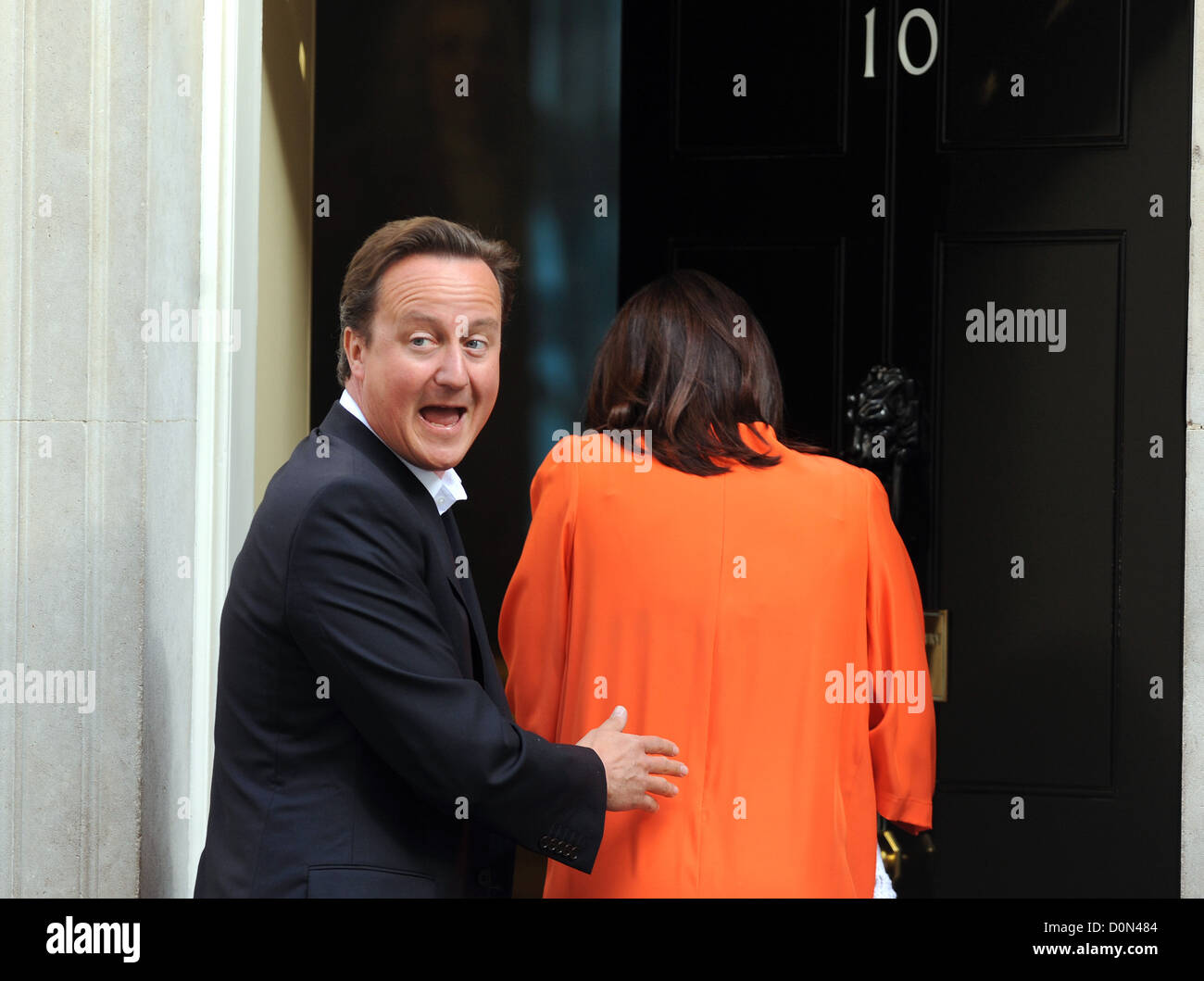 Prime Minister David Cameron returns to 10 Downing Street with his wife ...