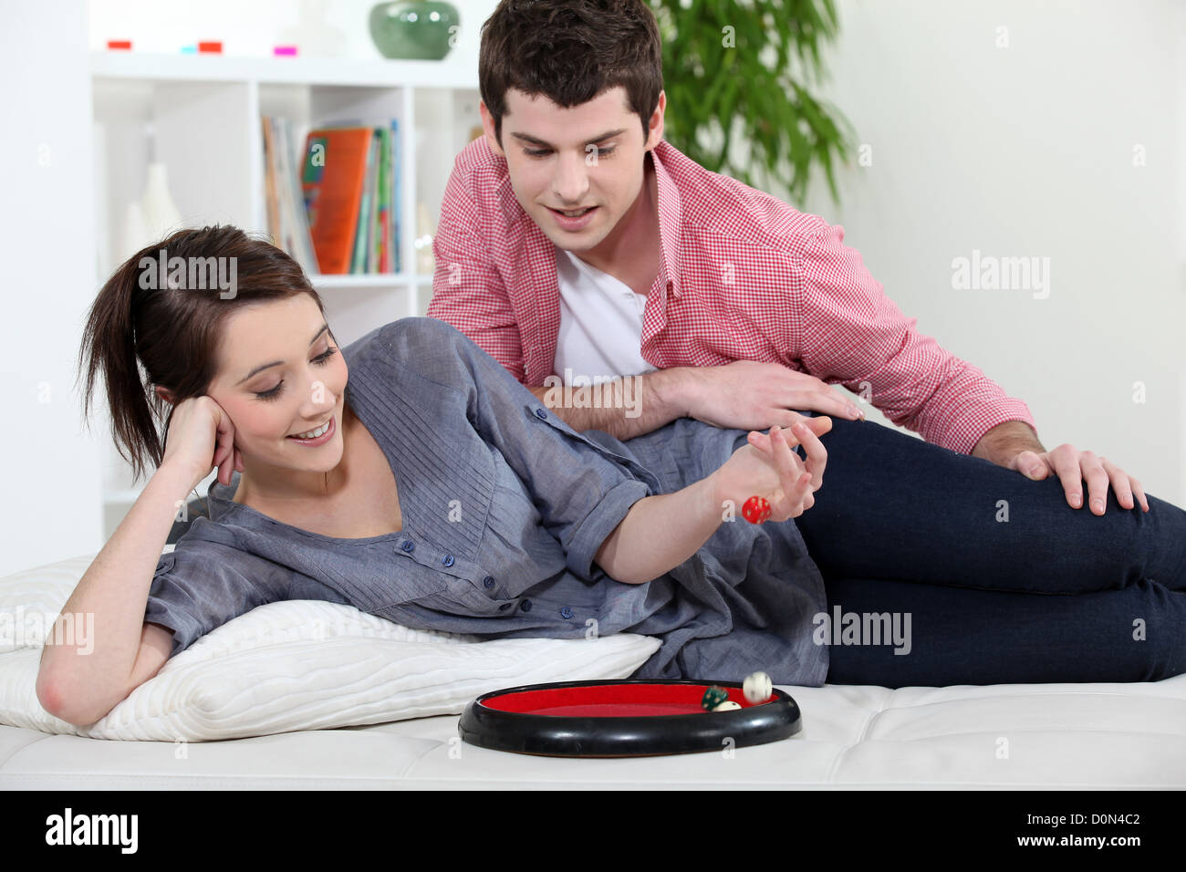 Couple playing dice Stock Photo - Alamy