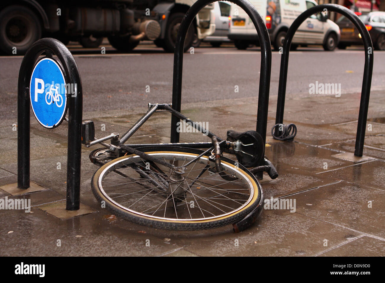 A vandalised bike still chained to a cycle rack in London Stock Photo ...