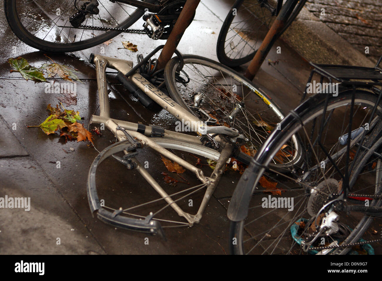 A vandalised bike still chained to a cycle rack in London Stock Photo ...