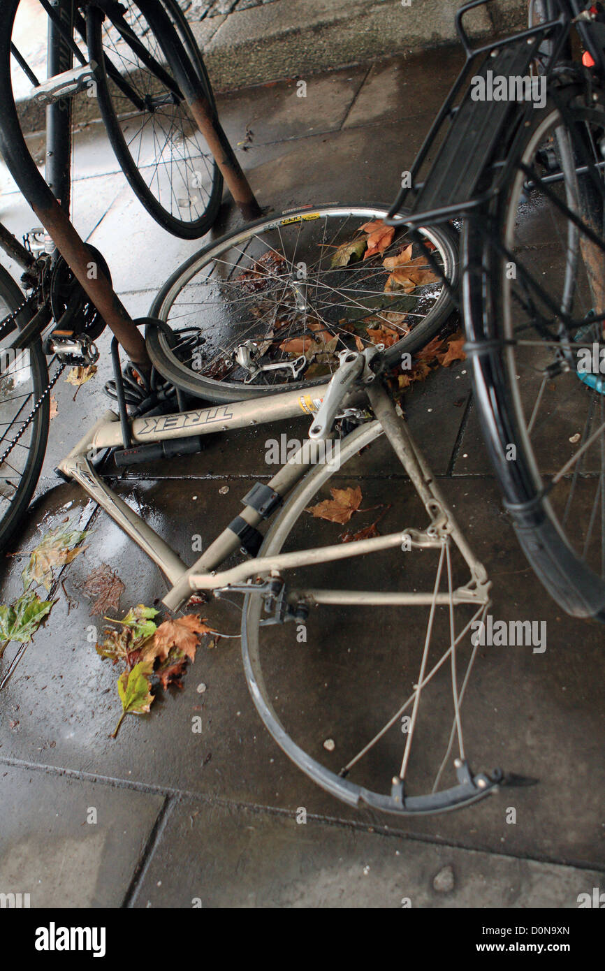 A vandalised bike still chained to a cycle rack in London Stock Photo ...