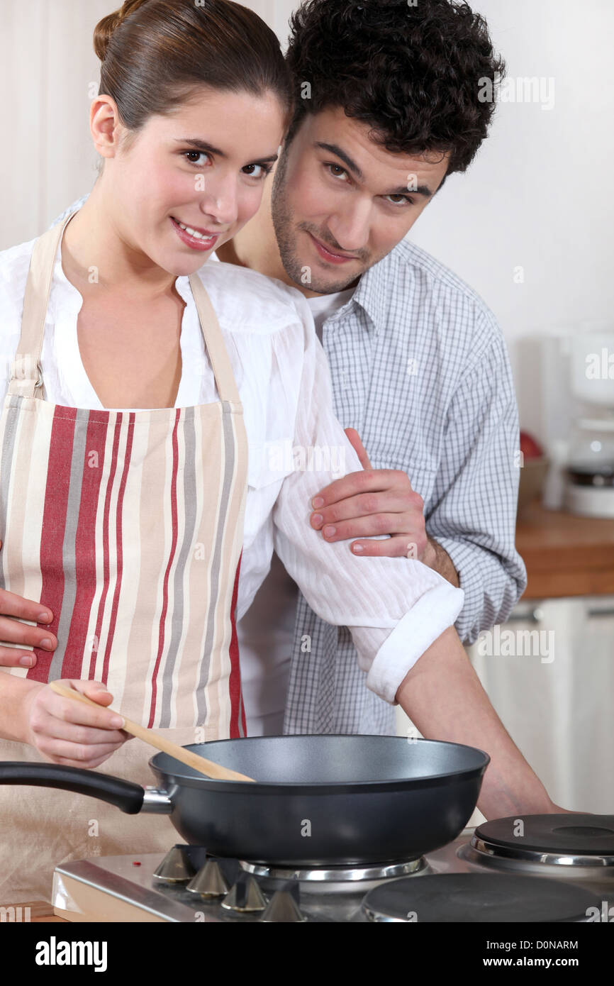 Couple cooking in their kitchen Stock Photo - Alamy