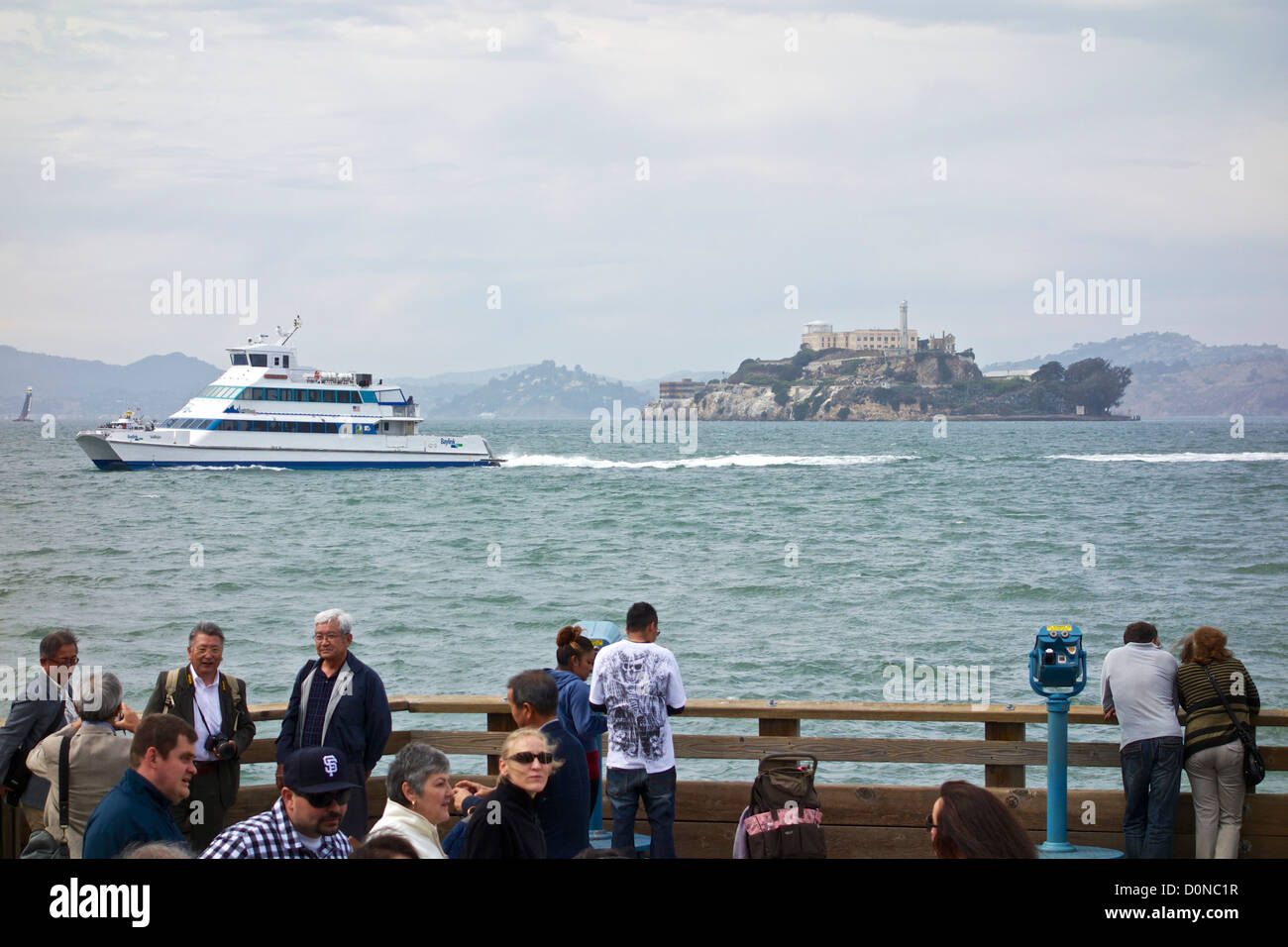 Tourists Pier 39 San Francisco California. Alcatraz Island and ferry ...