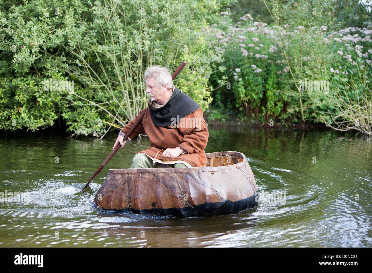Man using coracle at Pensthorpe Gardens in Norfolk Stock Photo - Alamy