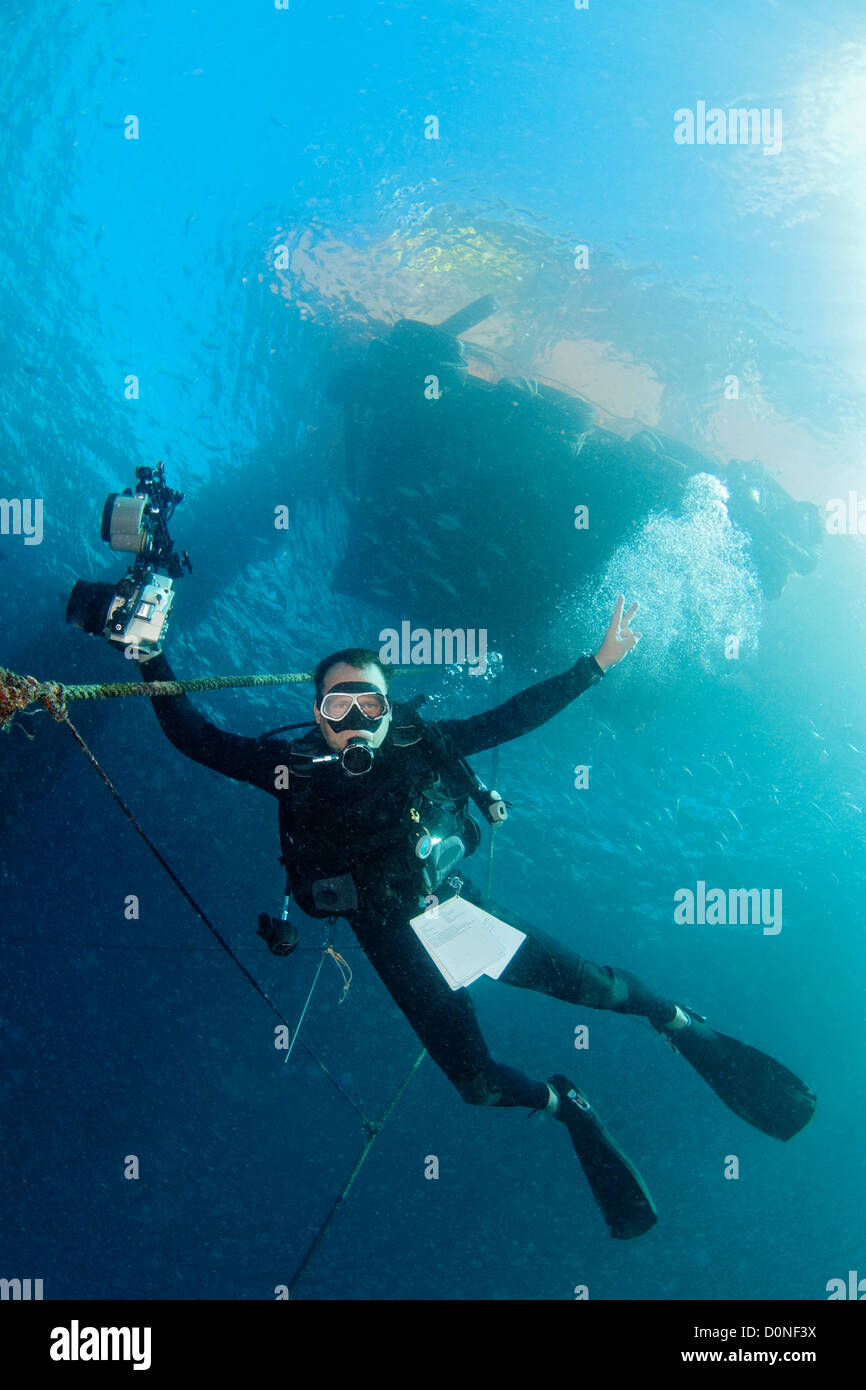 A photographer at a decompression stop just beneath the lift platform ...
