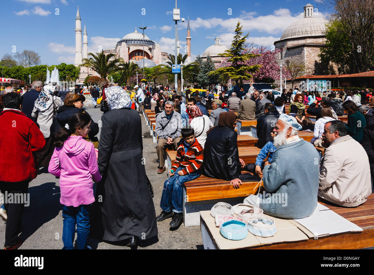 Many Turkish people sitting and walking in Sultanahmet park with Haghia ...
