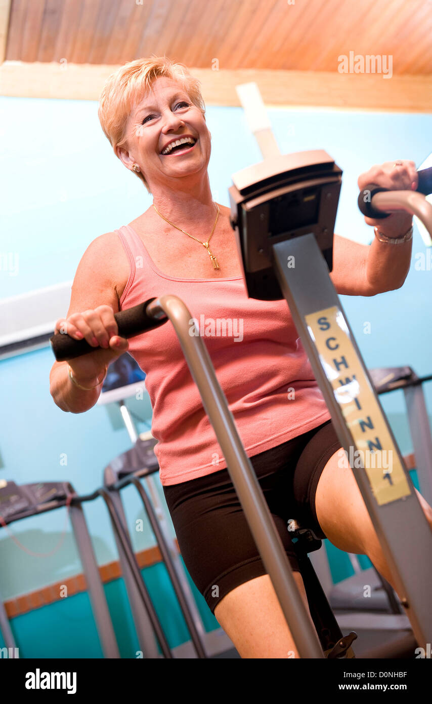mature woman using fitness machine in gym Stock Photo - Alamy
