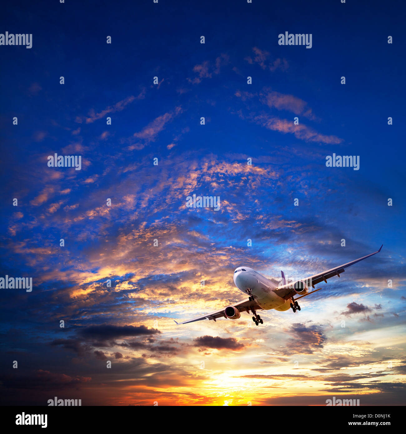 Jet plane in a sunset sky. Square composition Stock Photo - Alamy