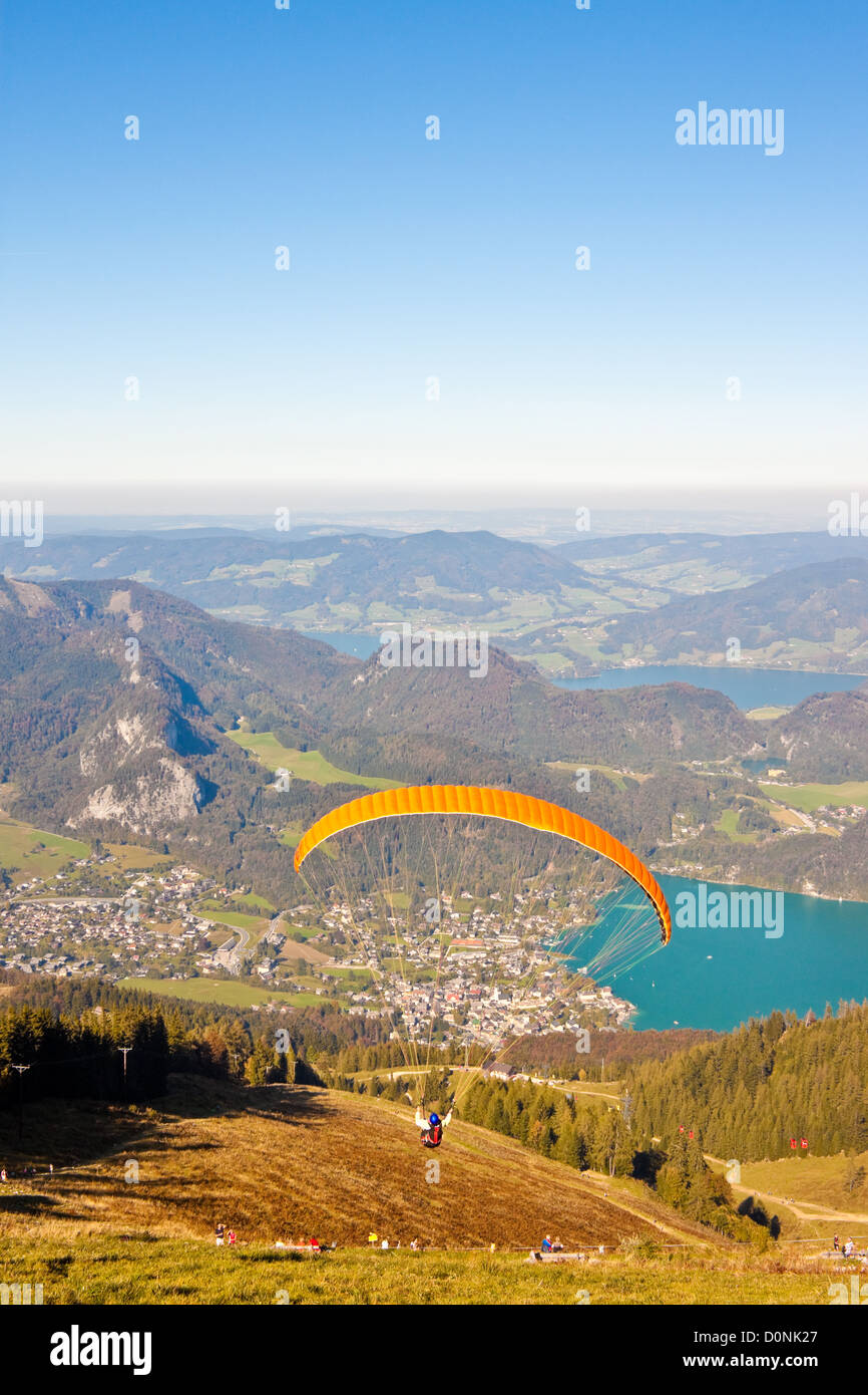 paragliding over mountains and Wolfgangsee lake in austrian Alps Stock ...