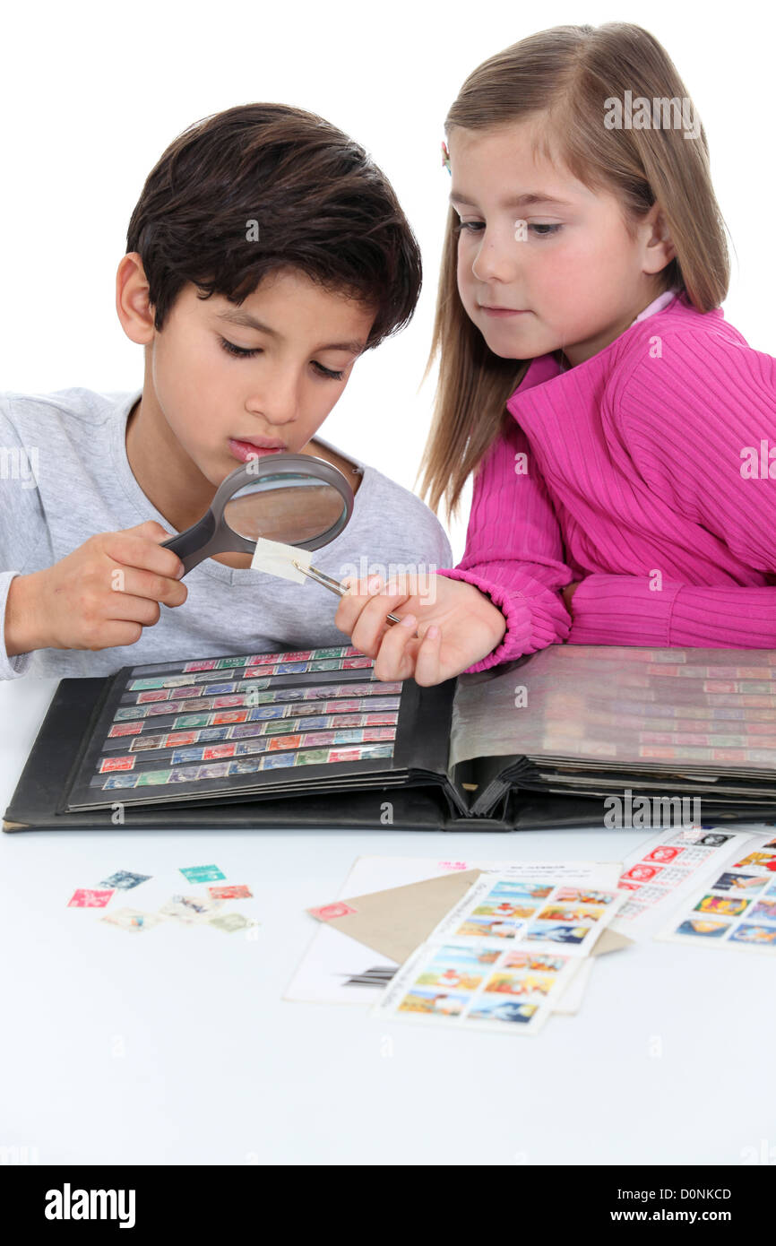 Two kids collecting stamps Stock Photo - Alamy